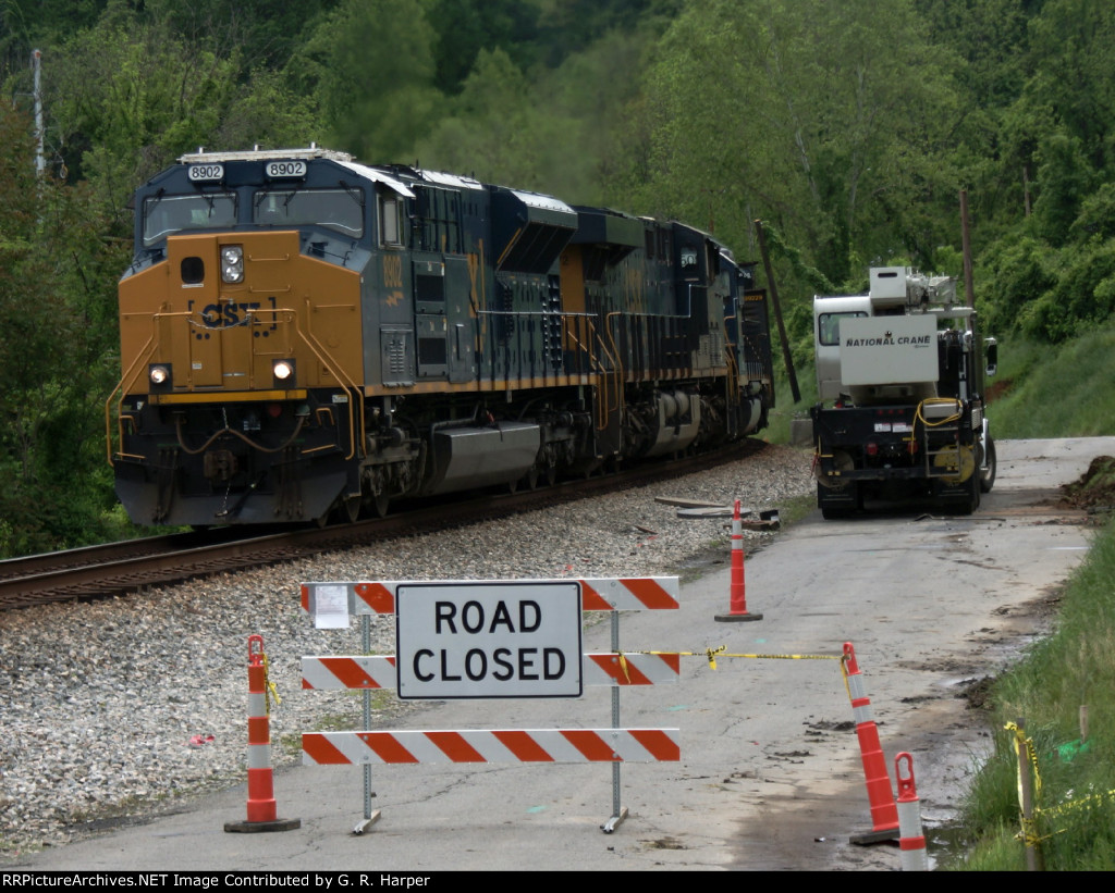 CSXT 8902 leads H75104 past a closed Hydro Street occupied by crane at rest... they got rained ...